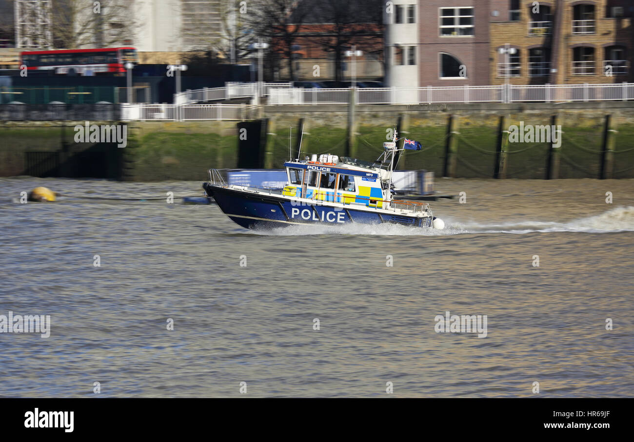 A London Metropolitan Police launch travels at speed along the River ...