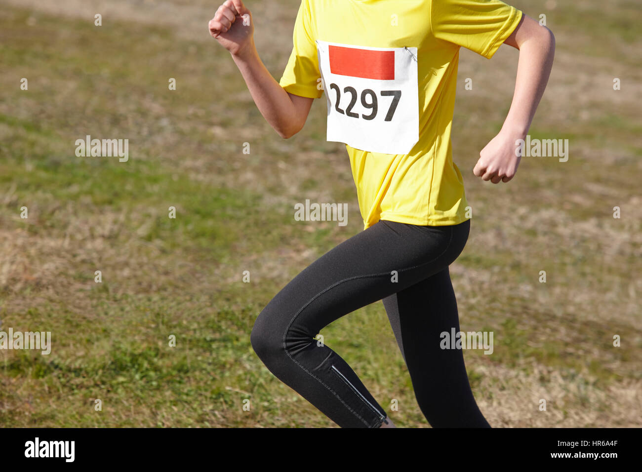 Young athletic runner on a cross country race. Outdoor circuit ...