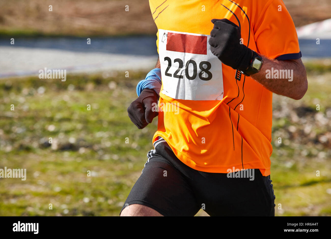 Male athletic runner on a cross country race. Outdoor circuit ...