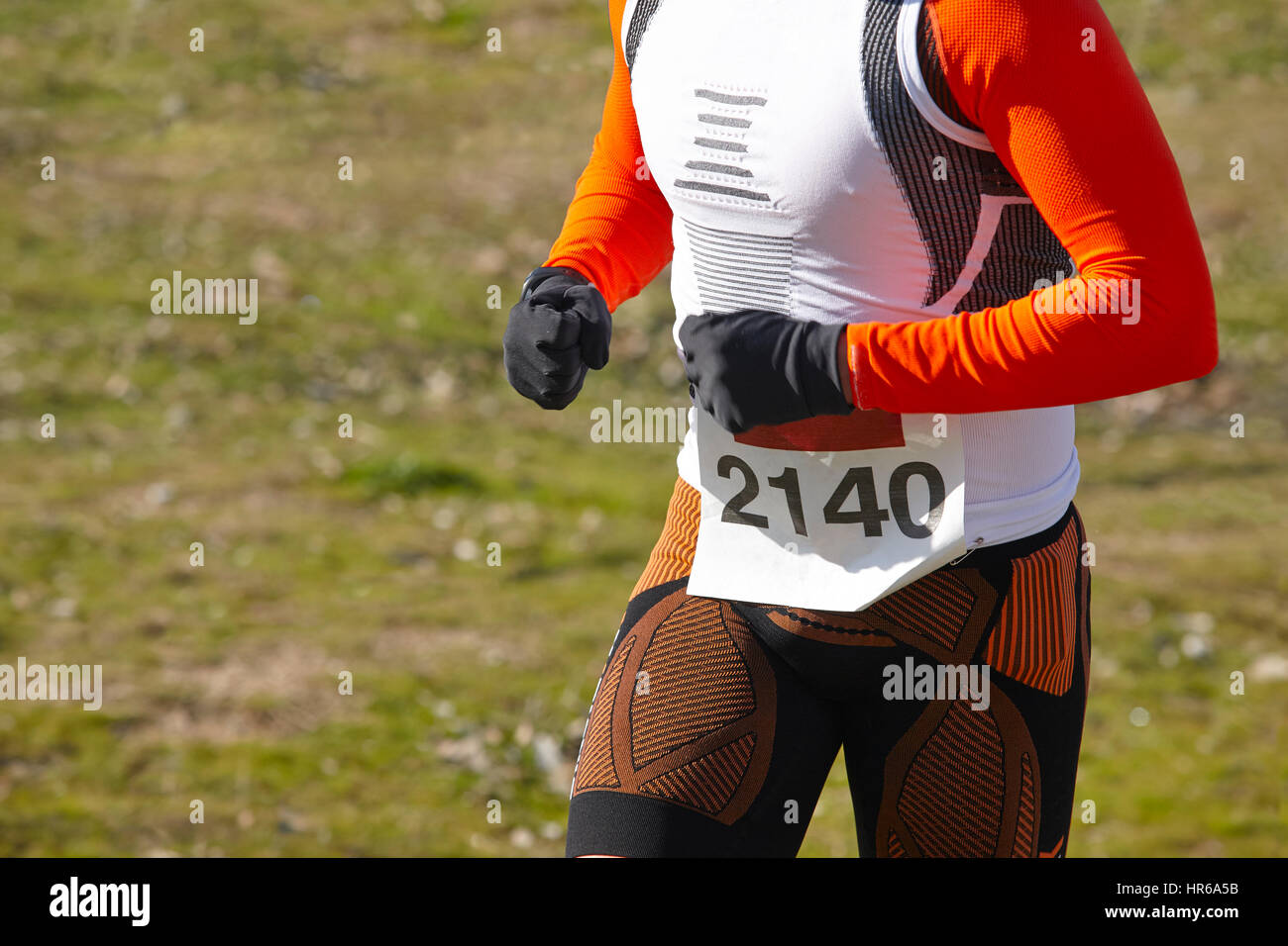 Young athletic runner on a cross country race. Outdoor circuit ...