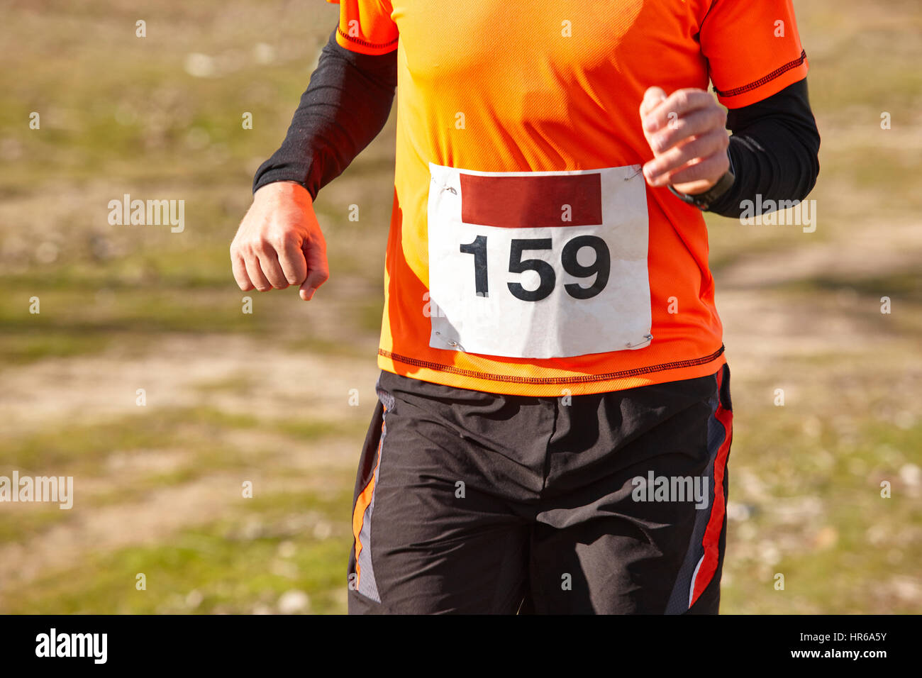 Male athletic runner on a cross country race. Outdoor circuit ...