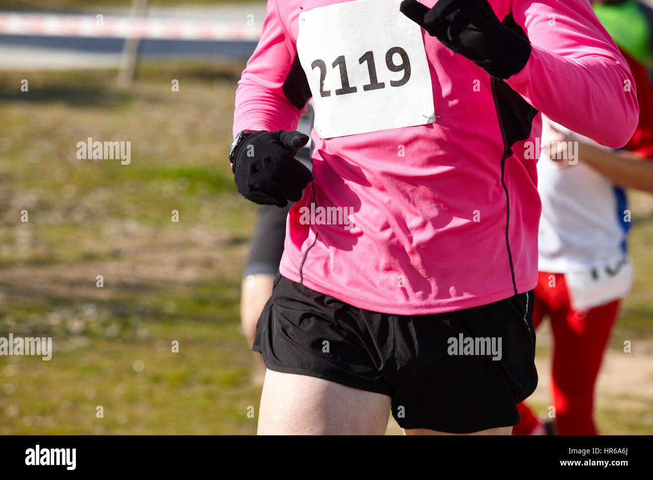 Male athletic runners on a cross country race. Outdoor circuit ...