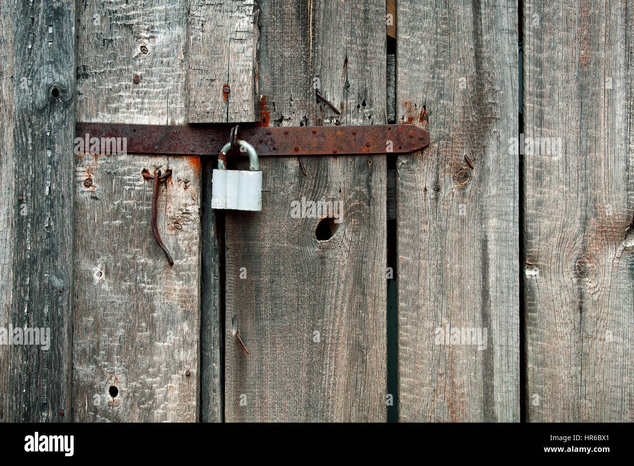 Old latch with padlock on doors Stock Photo - Alamy