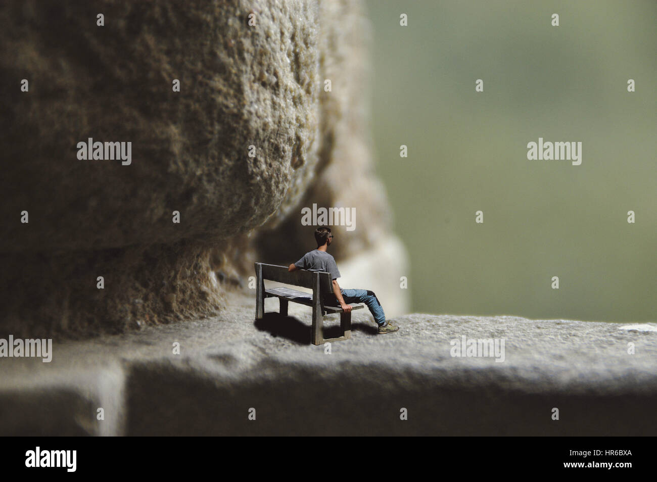 Man sitting on stone bench hi-res stock photography and images - Alamy