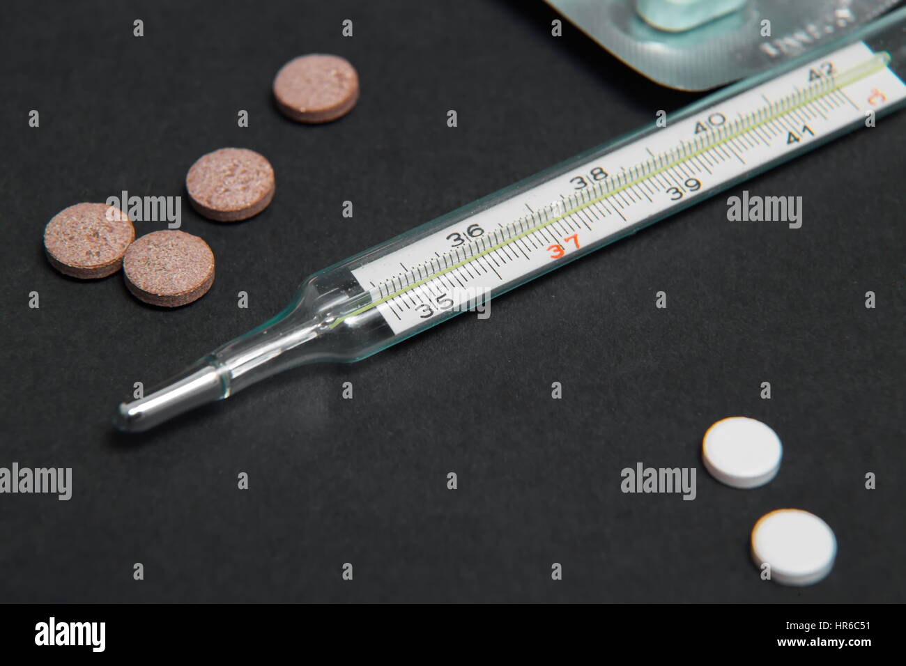 Bunch of blue pills with green injection in the background. Medical ...