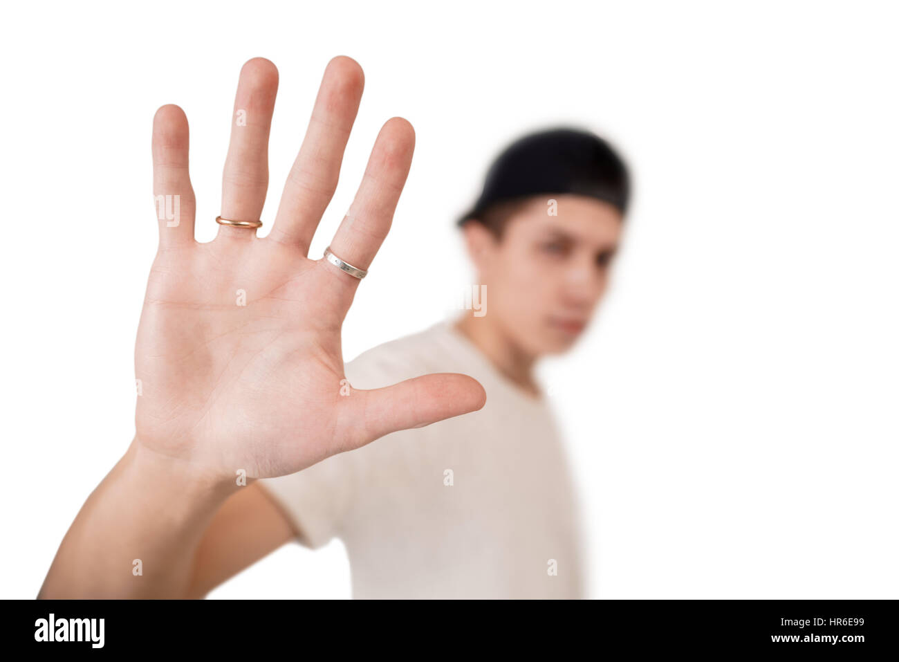 Young handsome rap dancer in black baseball cap showing his palm with ...