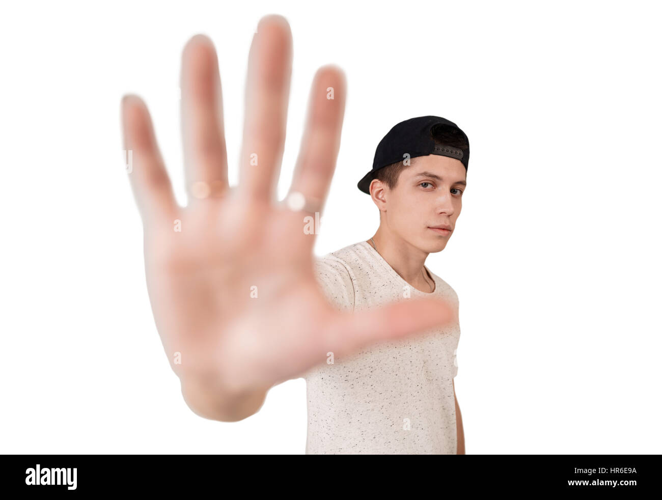 Young handsome rap dancer in black baseball cap showing his palm with ...