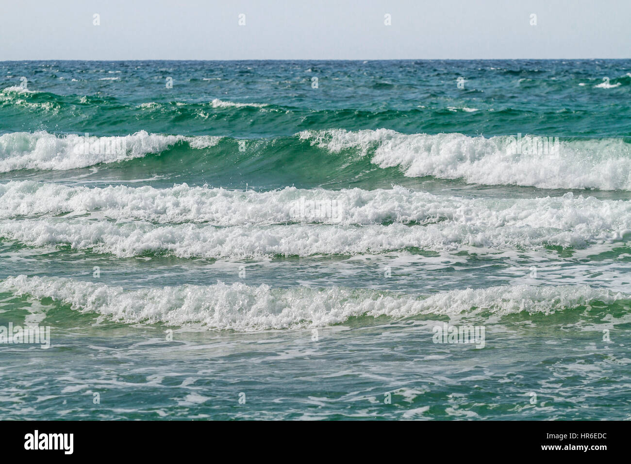 Waves of light from the rising sun, on a background of blue sky Stock ...