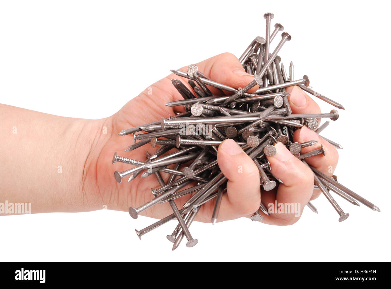 Man's hand holding metal nails. Closeup with clipping path isolated on ...