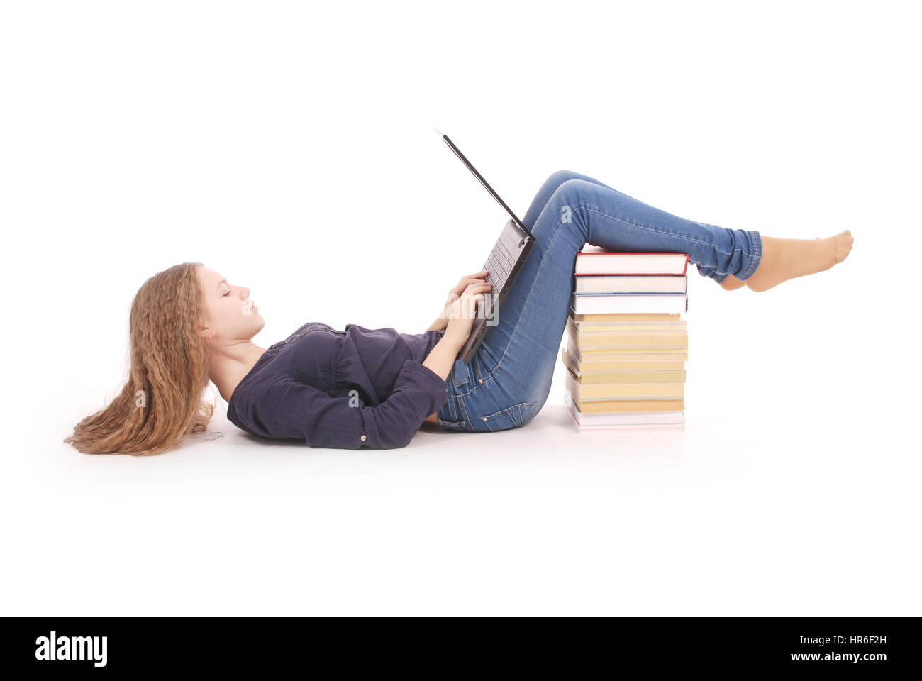 Student teenage girl lying sideways on the floor with laptop isolated ...