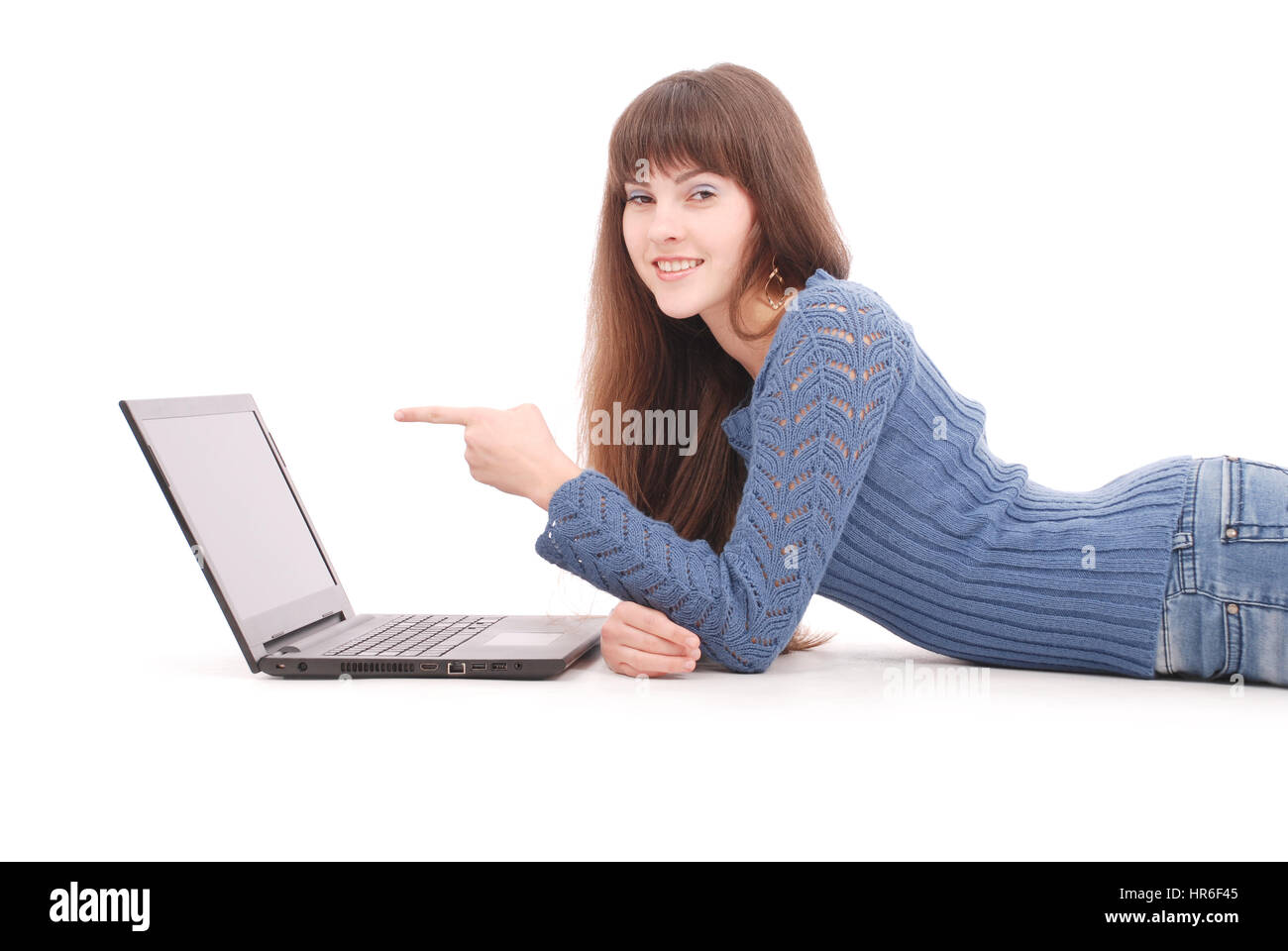 Young woman lying on floor using laptop. Young caucasian woman lying ...