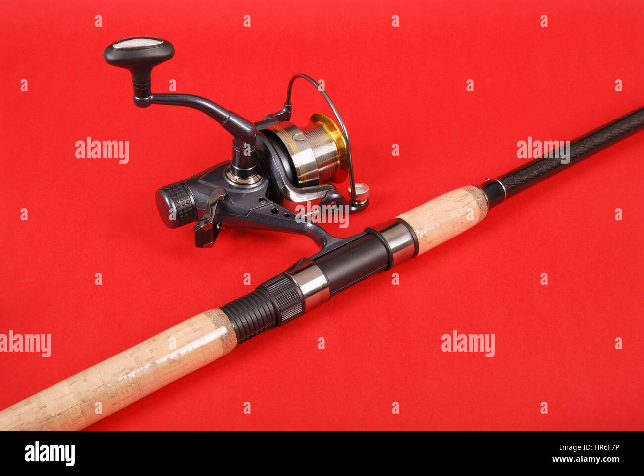 Fishing rod on red background with soft shadow Stock Photo - Alamy