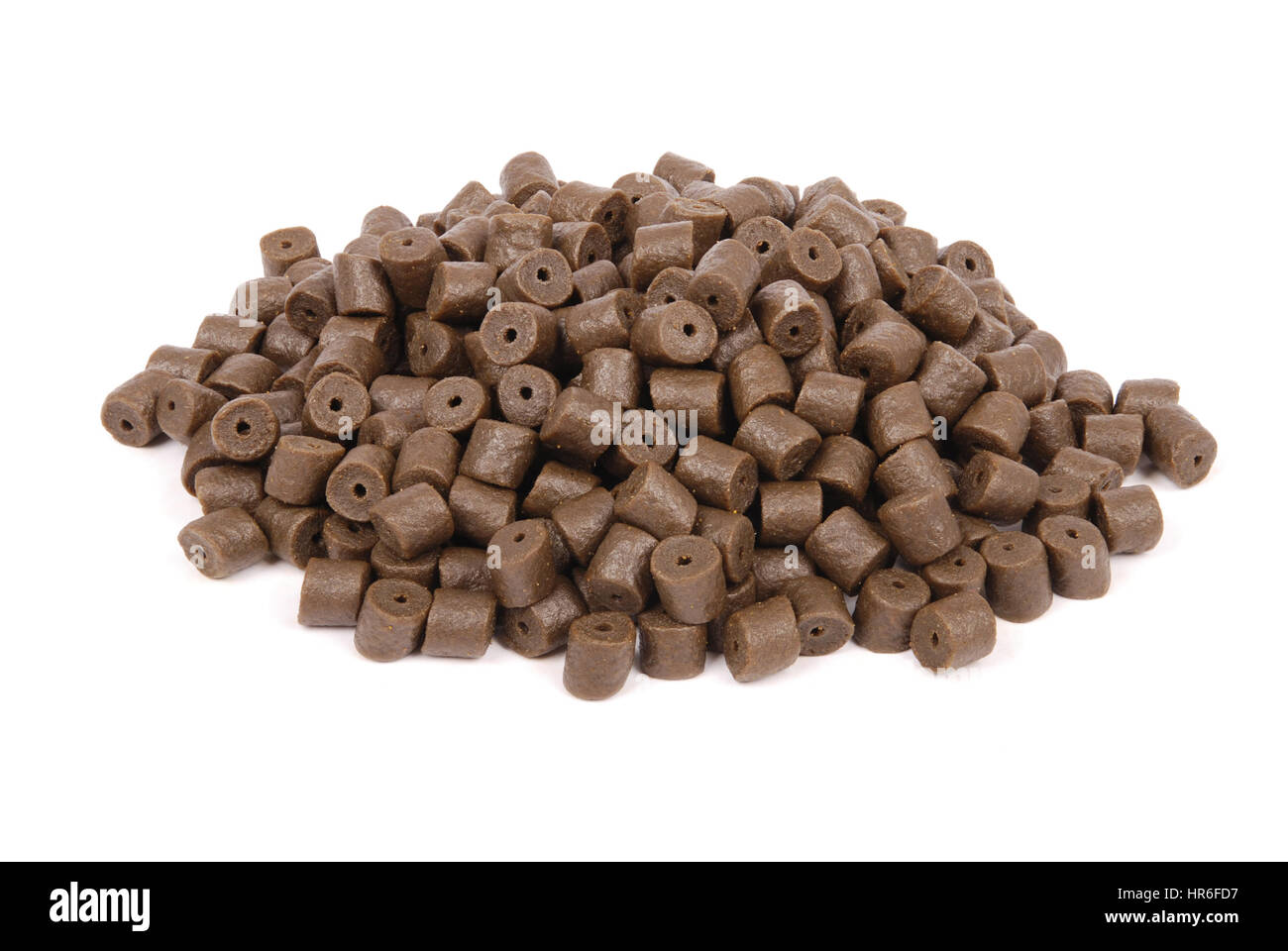 Brown pre-drilled halibut pellets for carp fishing isolated on white ...
