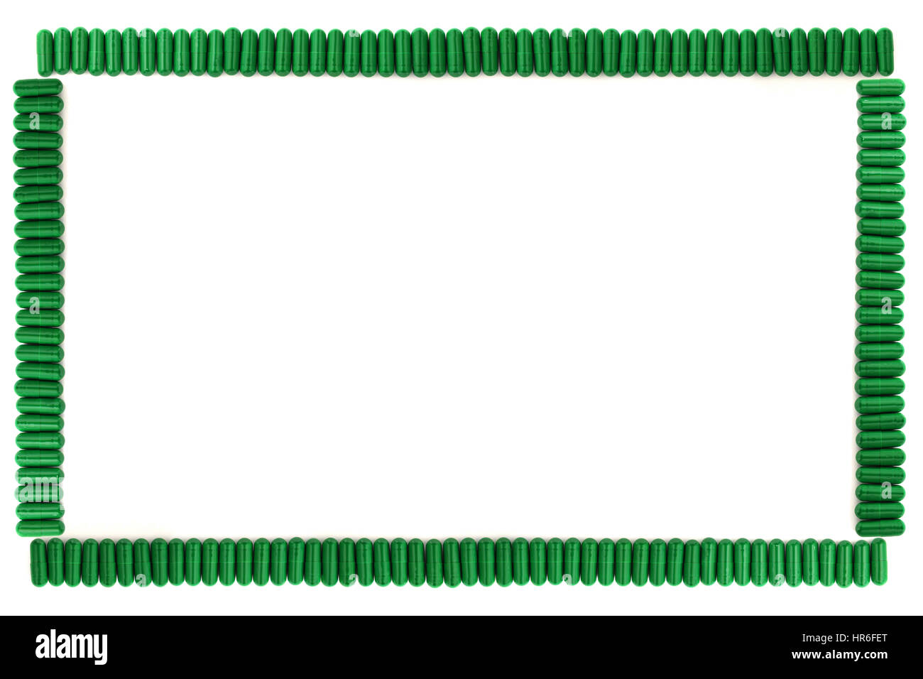 Frame from green capsules isolated on white background Stock Photo - Alamy