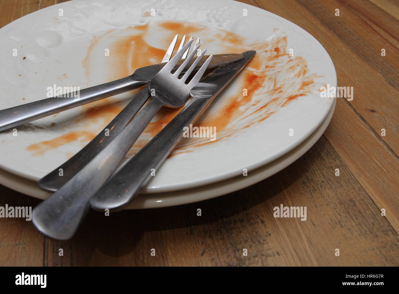 Dirty dinner plates and cutlery ready to be washed up Stock Photo - Alamy