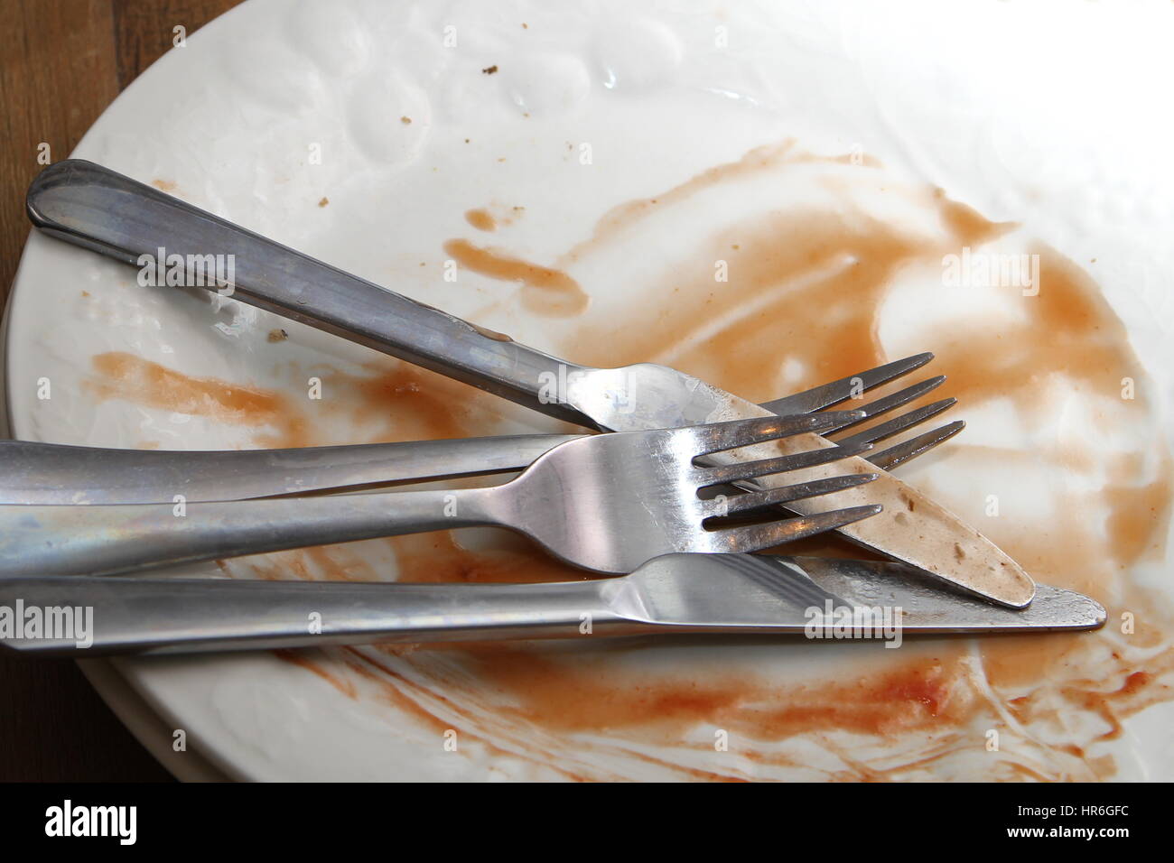 Dirty dinner plates and cutlery ready to be washed up Stock Photo - Alamy