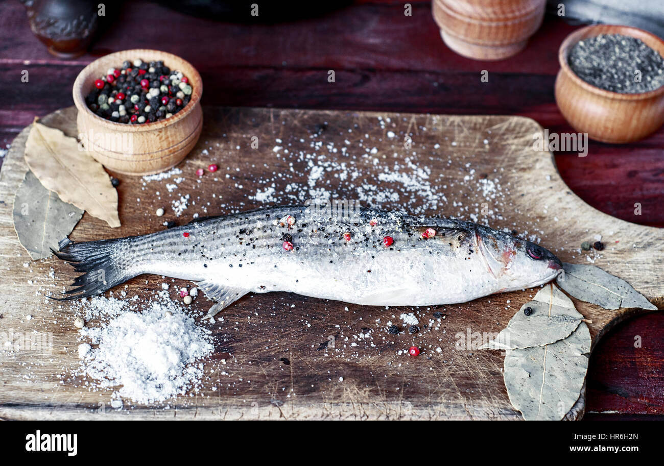 Live fish smelt on a kitchen board with spices Stock Photo - Alamy
