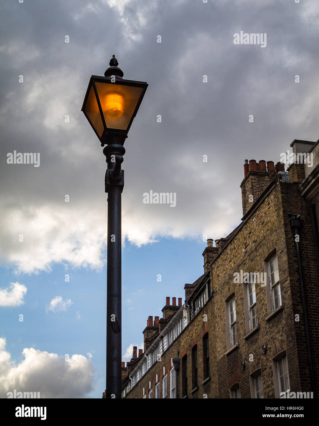 A lamp post with brick buildings in the background in East London Stock ...