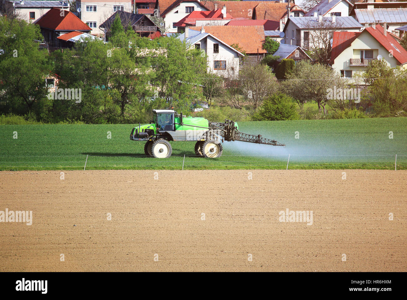 Tractor at farmers field. Agricultural spring work on field. Bright ...