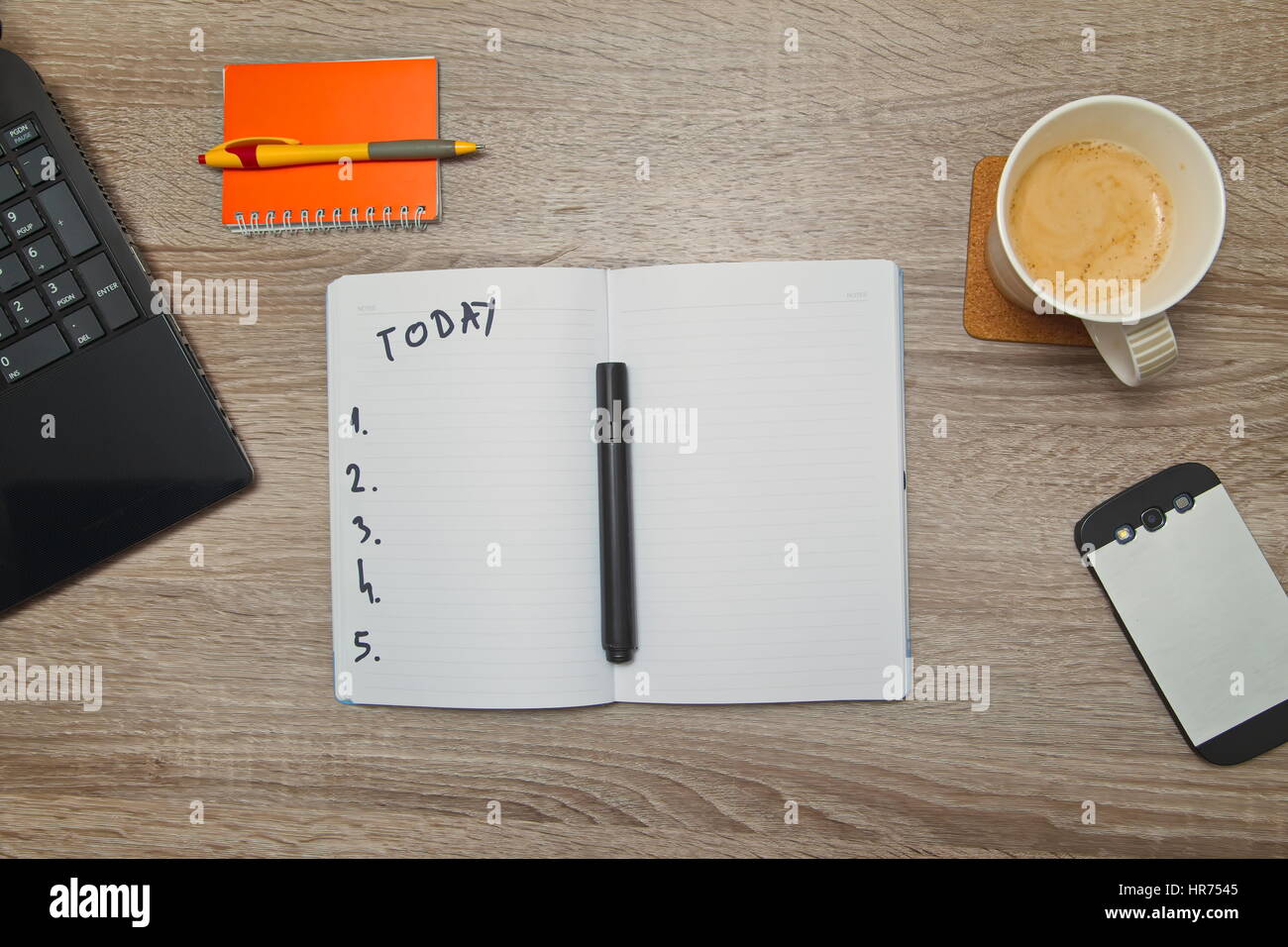 Open notebook with PLANS FOR TODAY and a cup of coffee on wooden ...