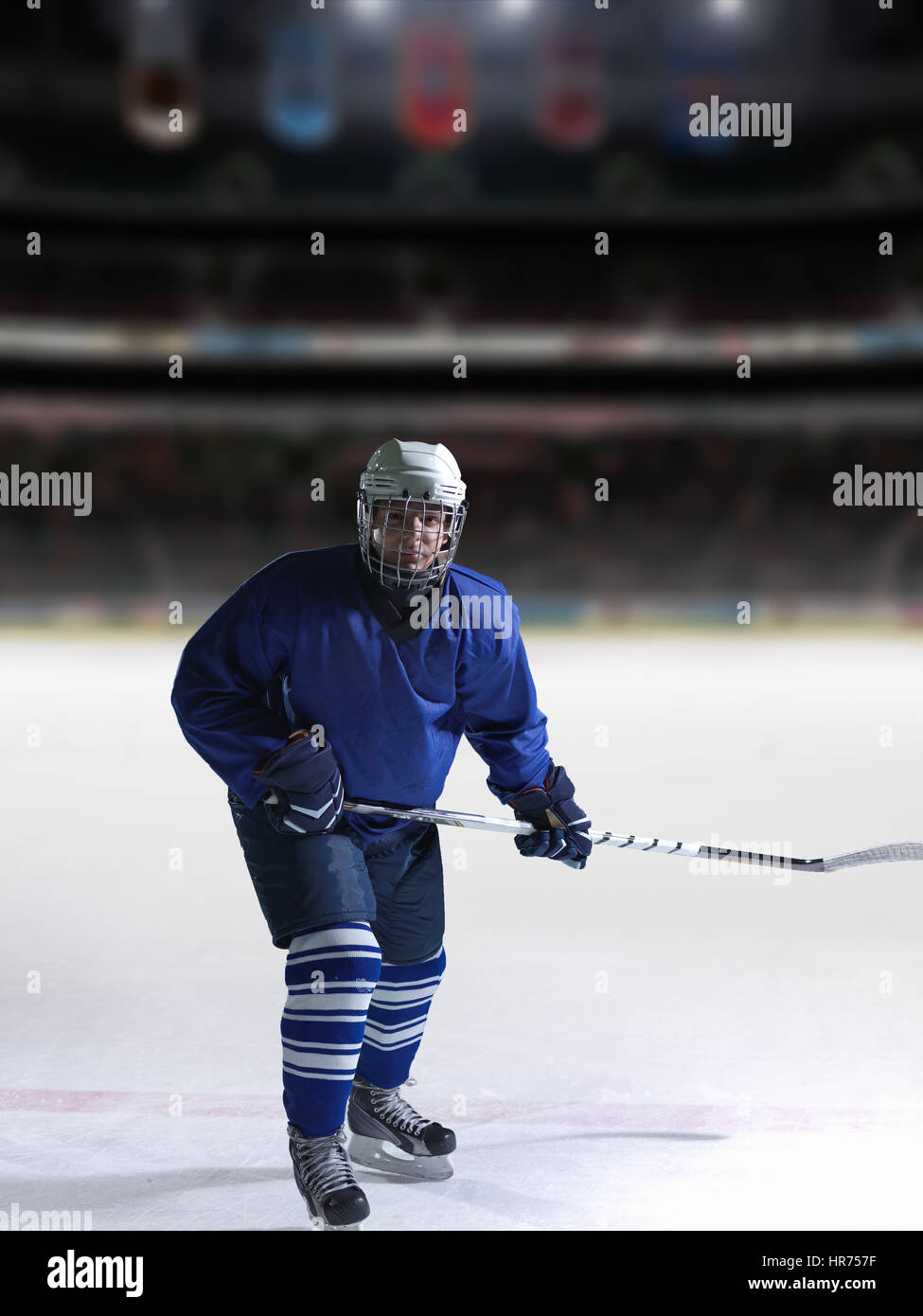 ice hockey player in action kicking with stick Stock Photo - Alamy