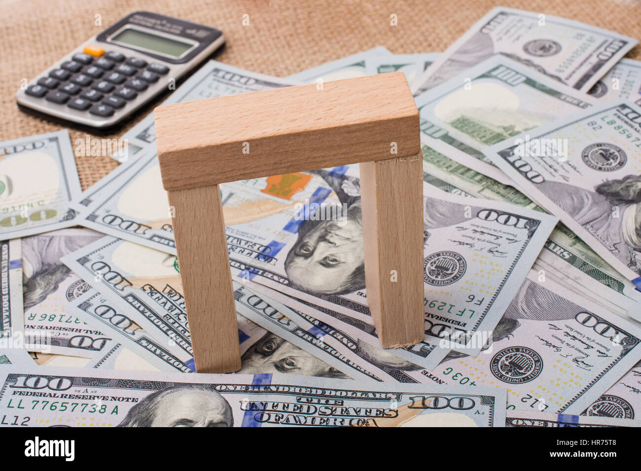 Wooden building blocks placed on spread US dollar Banknotes Stock Photo ...