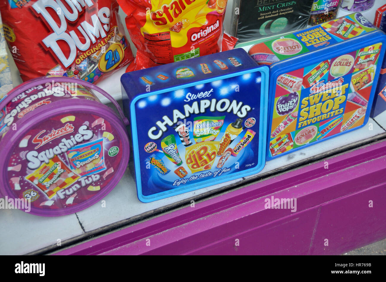Tins of sweets in a shop window Stock Photo - Alamy