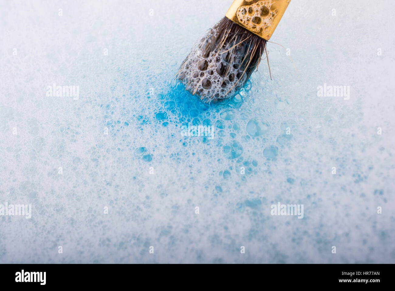 Paint dissolving in water as painting brush touching water Stock Photo ...