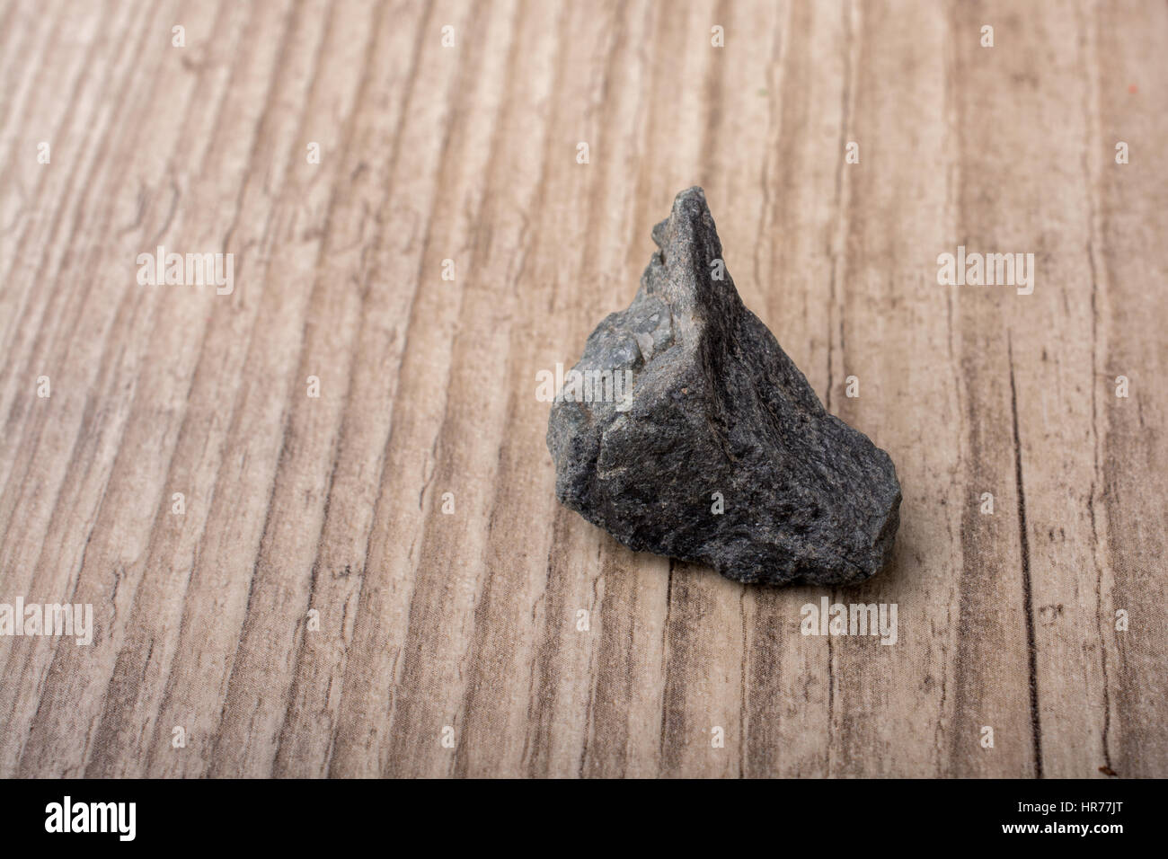 little gold color stone on wooden background Stock Photo - Alamy