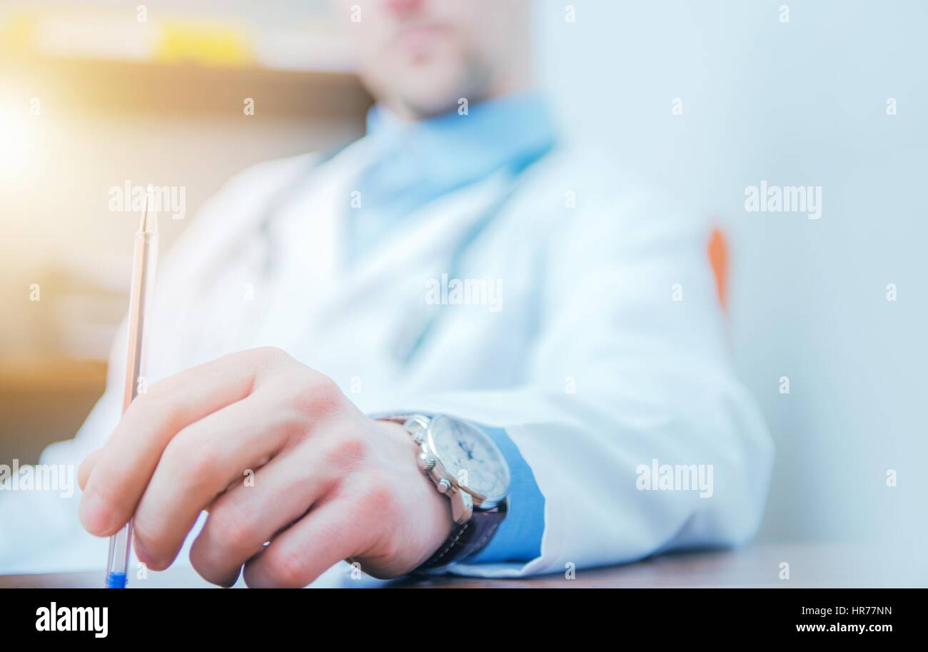 Confused Thinking Doctor Playing with His Pen While Seating in His ...