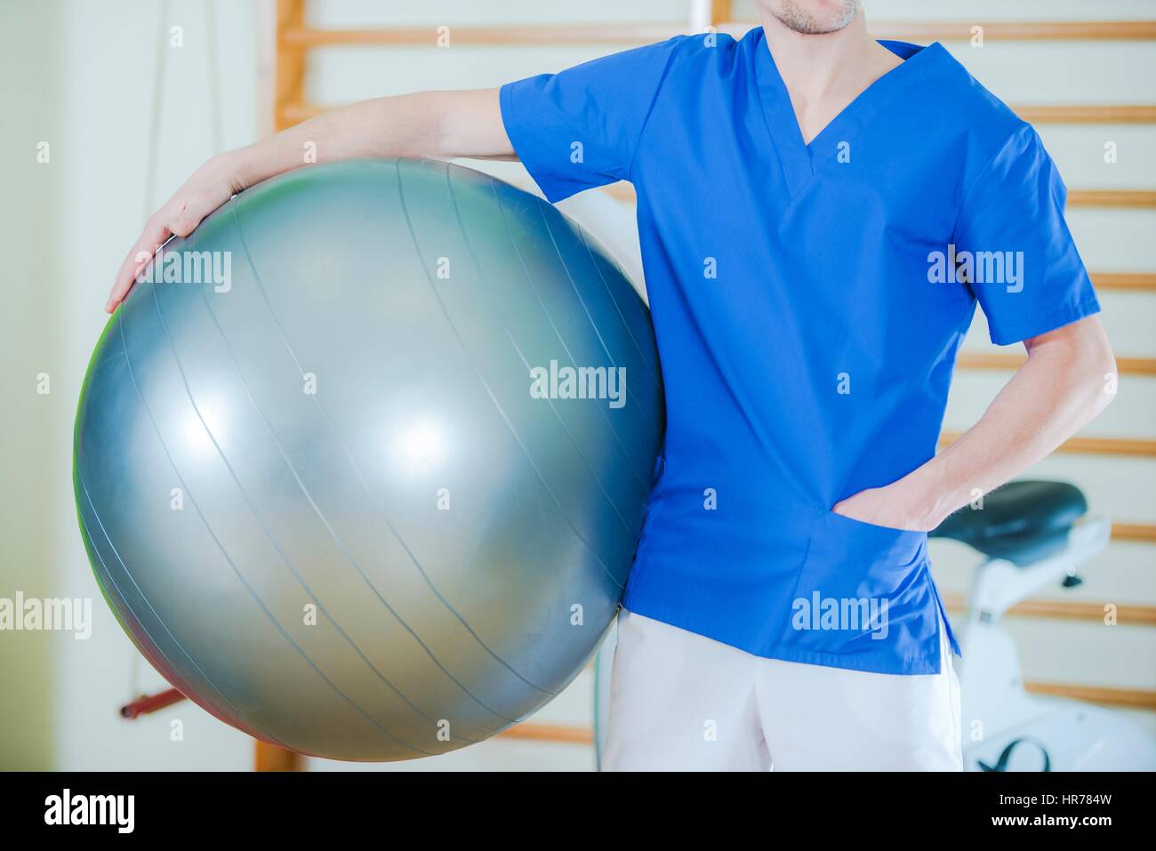 Caucasian Male Rehabilitation Specialist with Ball Awaiting Next ...