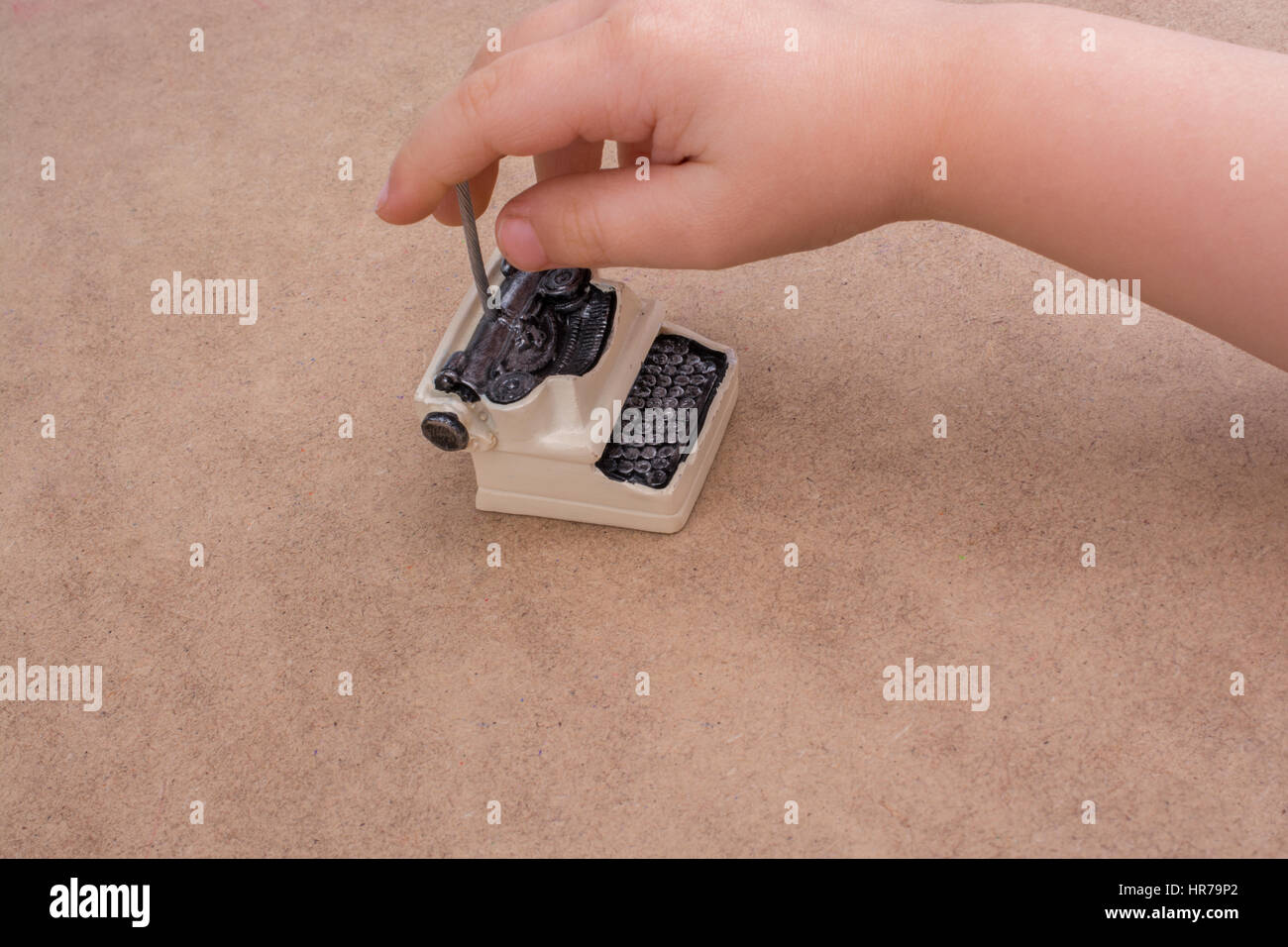 Hand holding a retro syled mini typewriter model Stock Photo - Alamy