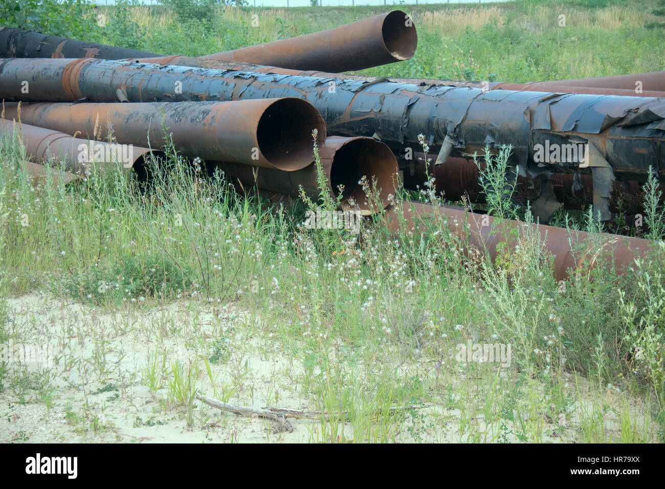 pipe engineering construction on sand. warehouse large pipes under open ...