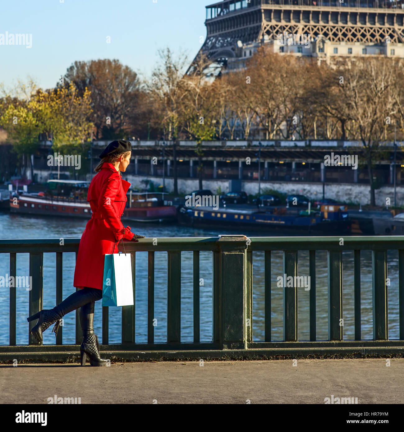 Bright in Paris. Full length portrait of modern woman in red trench ...