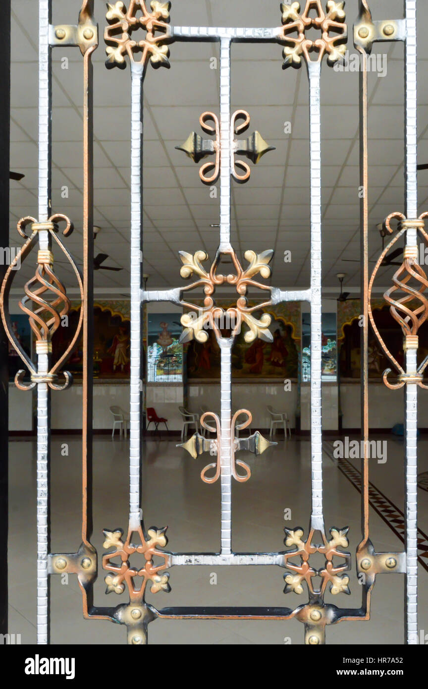 Wrought iron grid with gildings separate the entrance hall and the ...