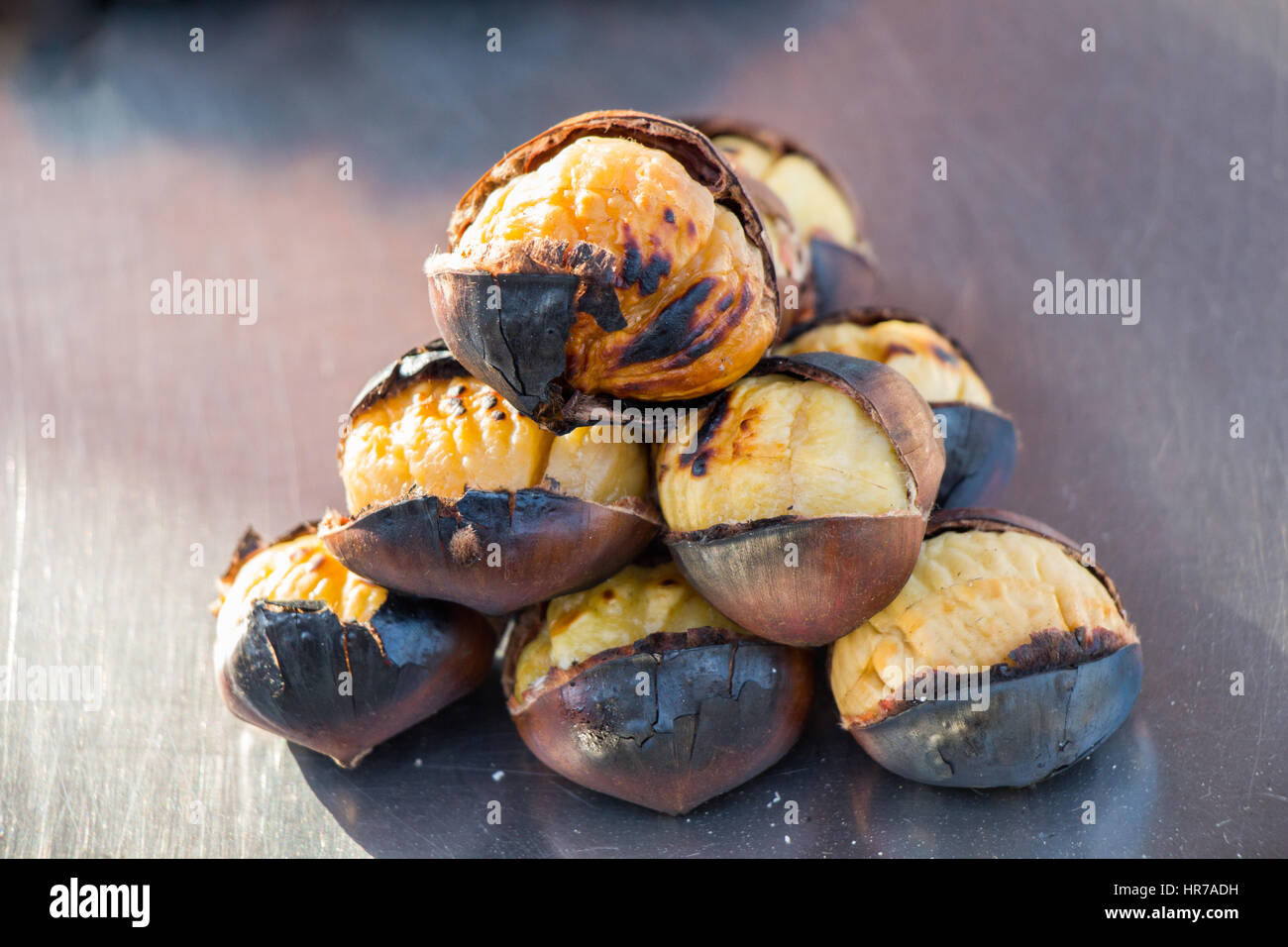 Organic brown chestnuts roasted over a hot fire Stock Photo - Alamy