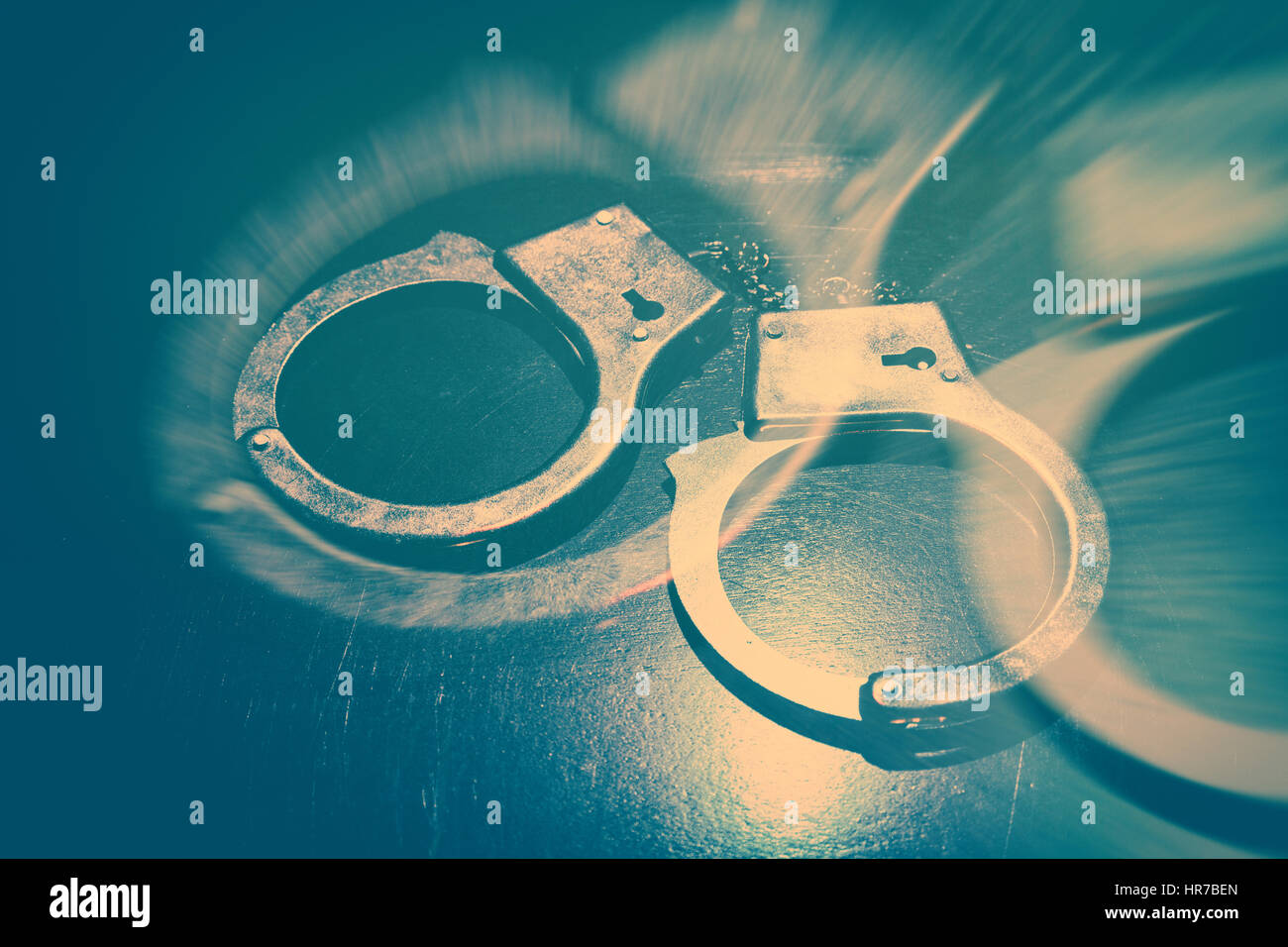 Metal handcuffs with dark background, close up Stock Photo - Alamy