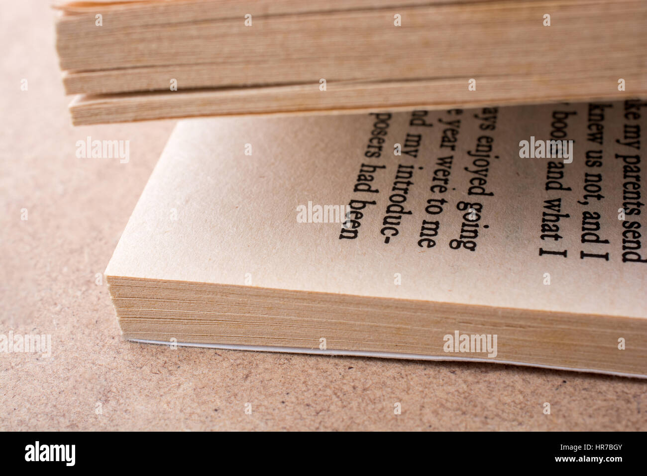 Book pages partly in view on white background Stock Photo - Alamy