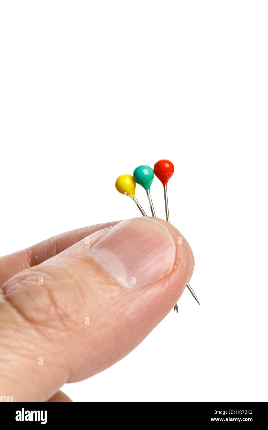 hand holding pins with a white background Stock Photo - Alamy