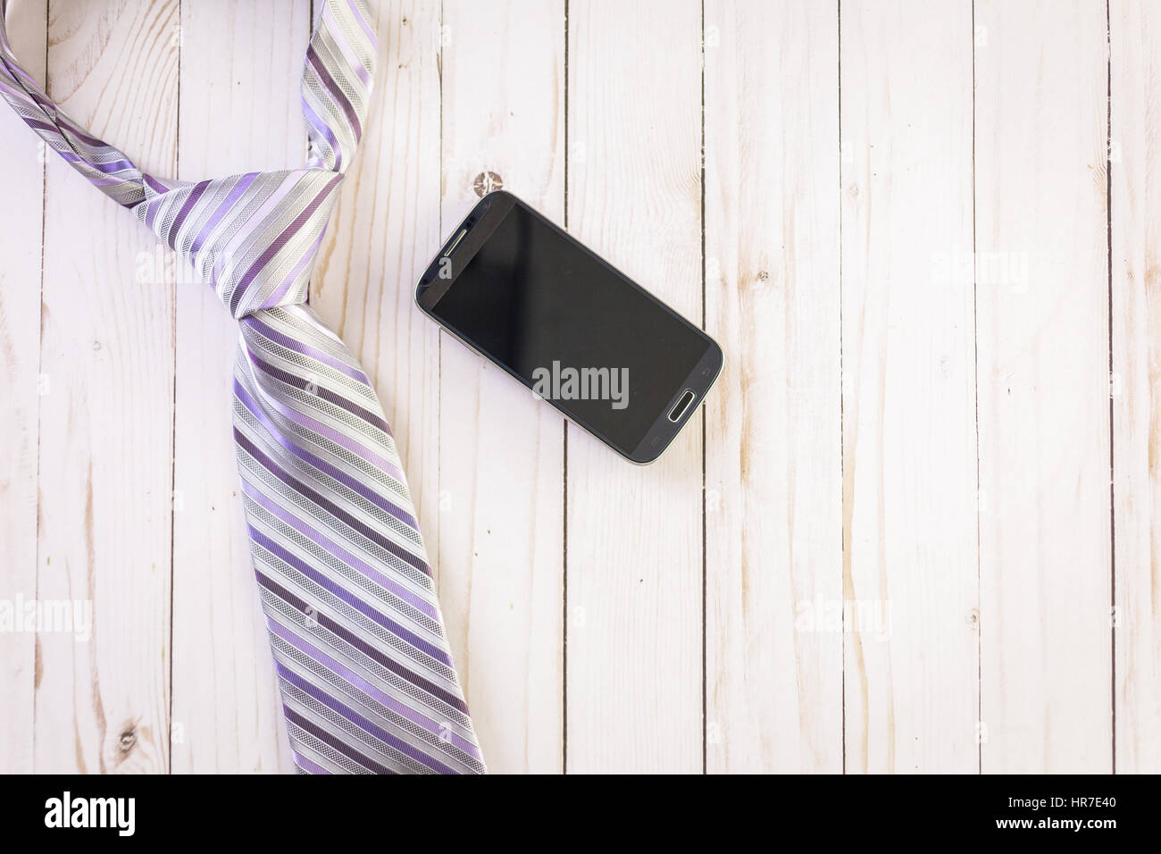 Men's tie with smart phone on a wood background Stock Photo - Alamy