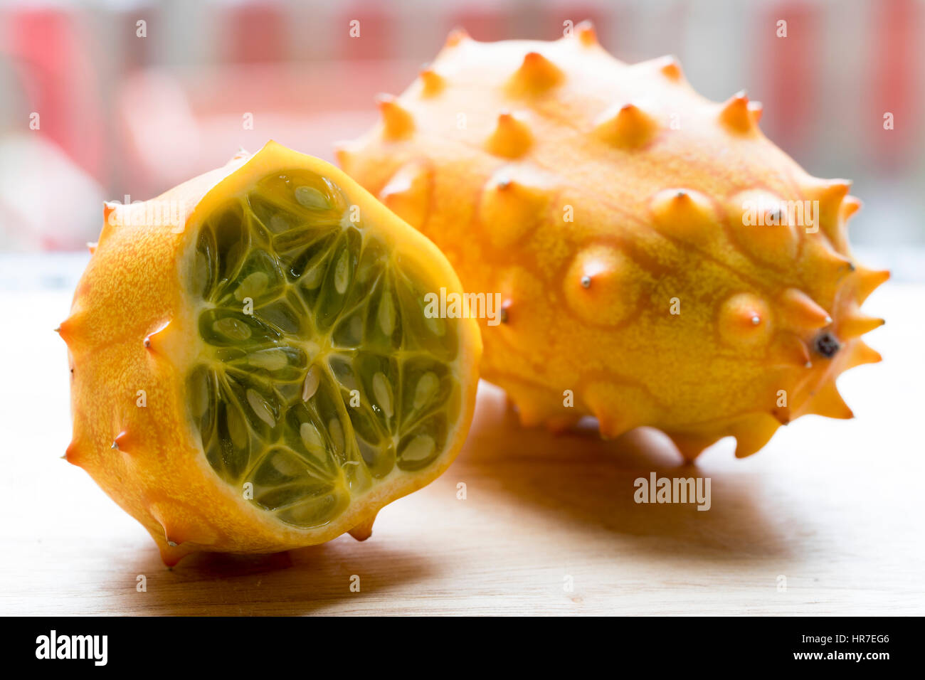 Whole and cut kiwano fruit on cutting board Stock Photo - Alamy