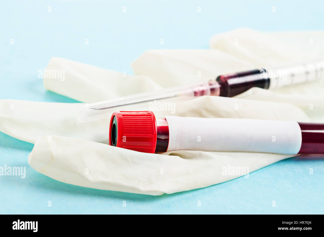 Sample blood for screening test and syringe with glove in laboratory ...