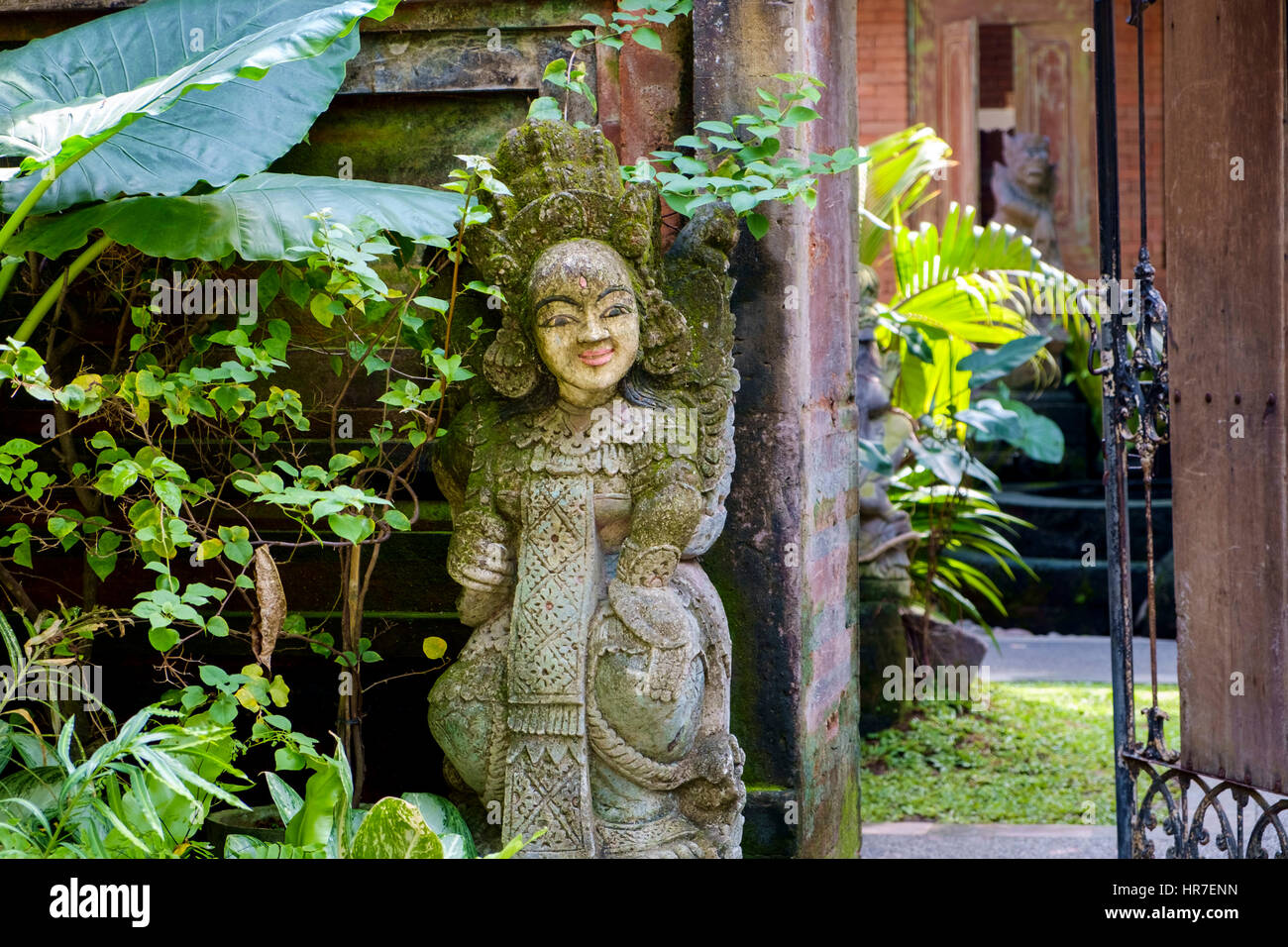 Statue of a Hindu deity in the garden of a traditional Balinese family ...