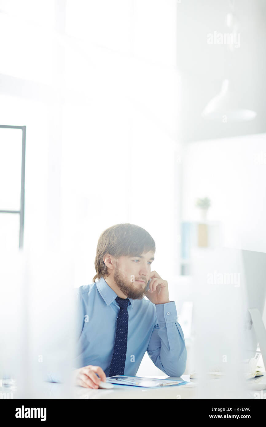 Portrait of successful young businessman wearing shirt and tie busy ...