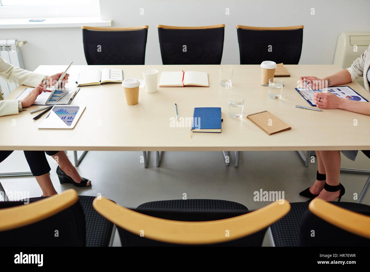 Two unrecognizable businesswoman leading negotiations sitting at ...