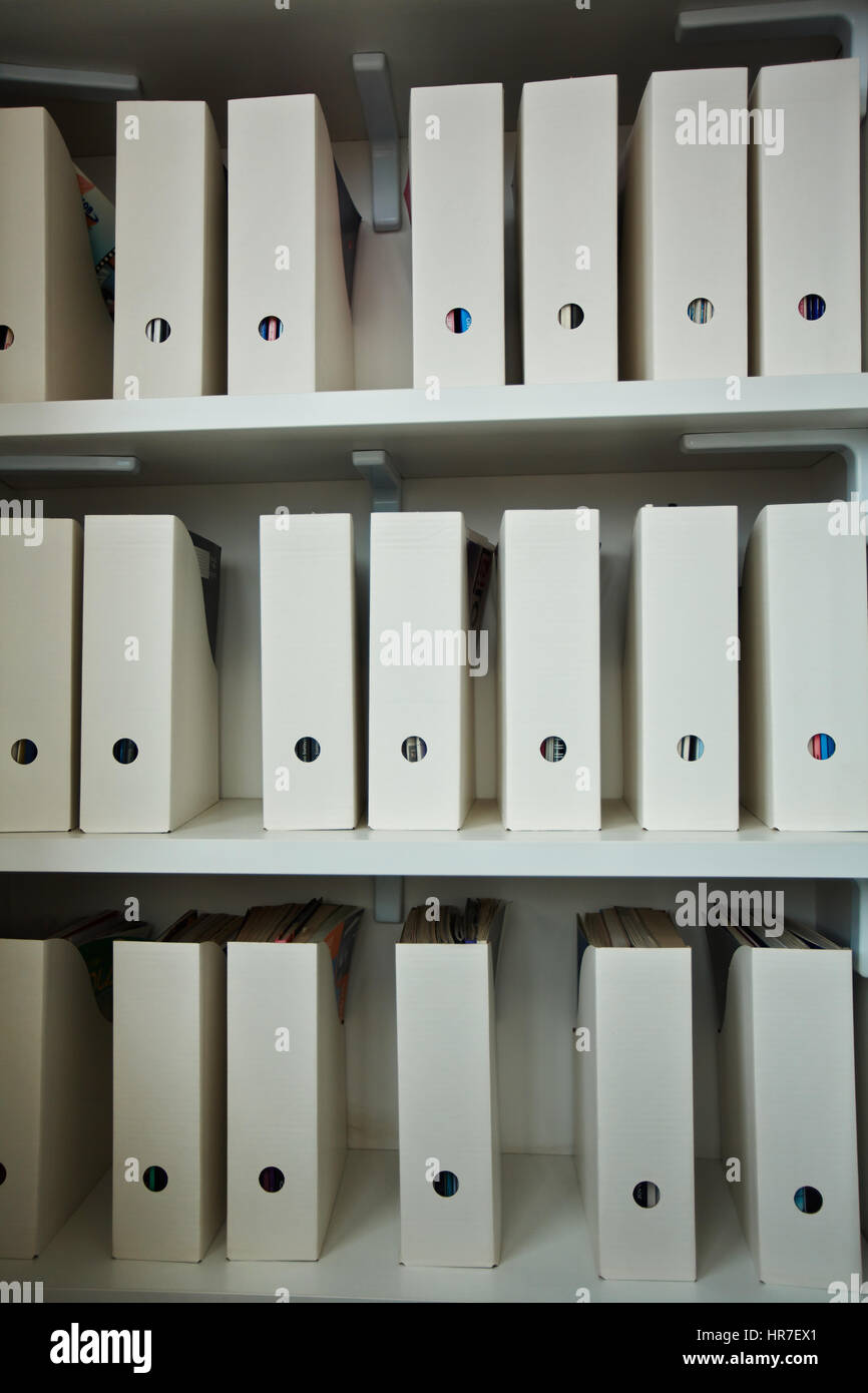 Front view of shelves with identical white documentation folders in ...