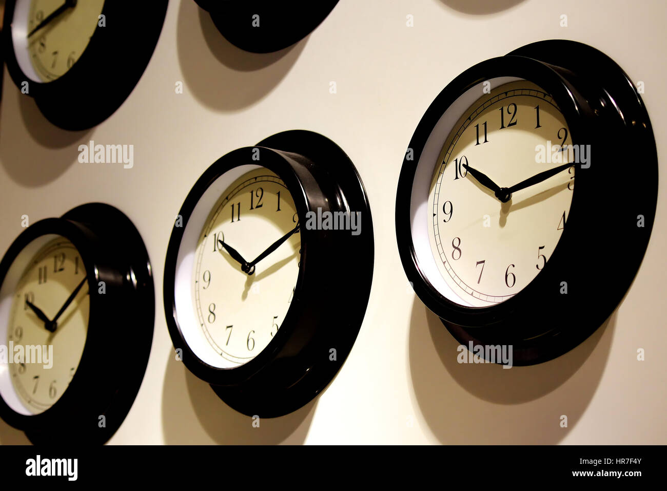 Group of Clock on the wall for a time concept Stock Photo - Alamy
