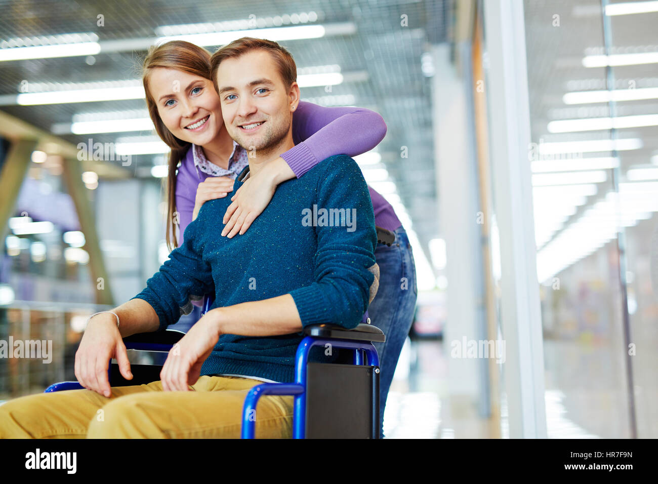 Portrait of young happy couple: pretty girl hugging her smiling ...
