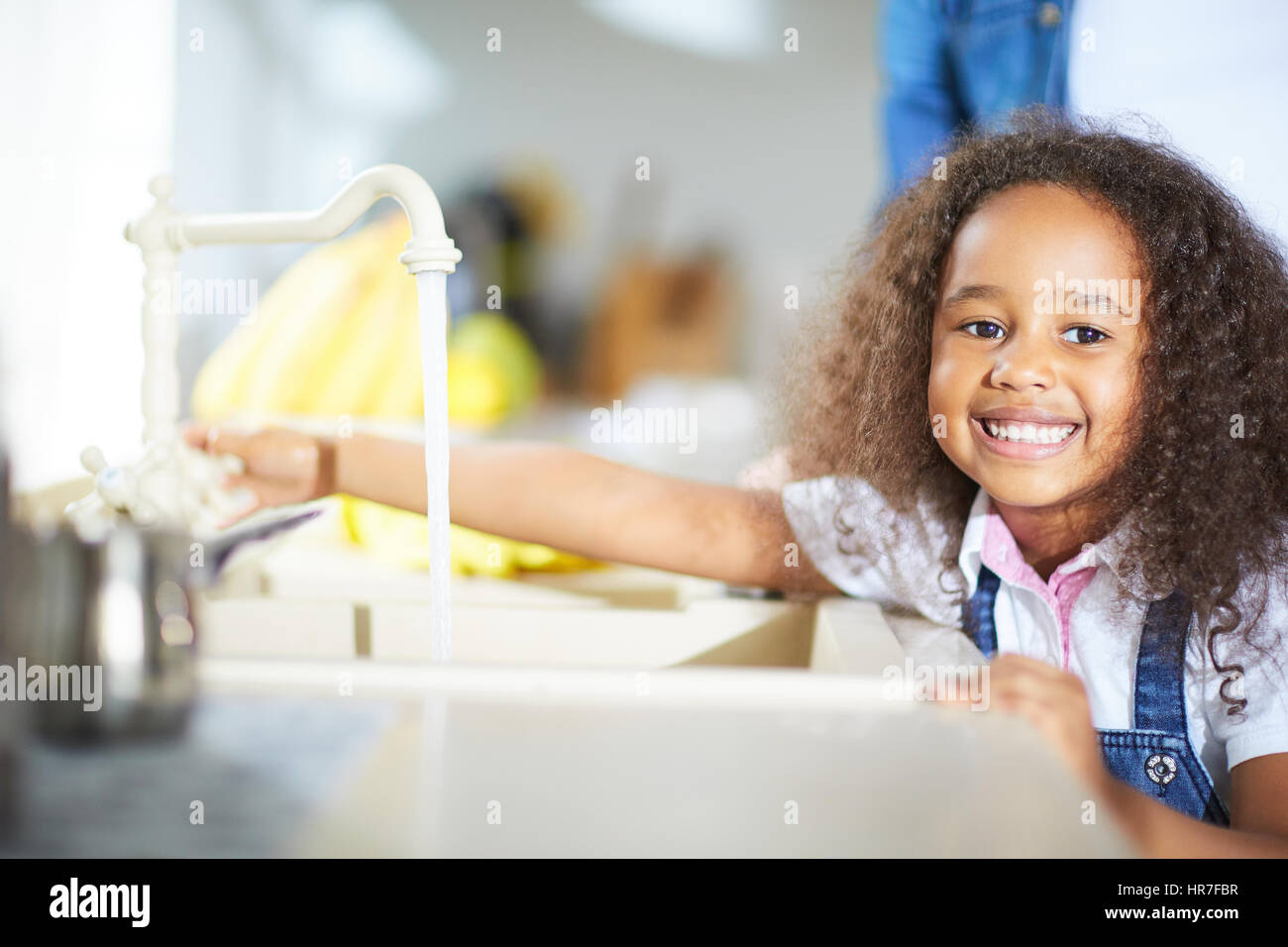 Child turning of tap hi-res stock photography and images - Alamy
