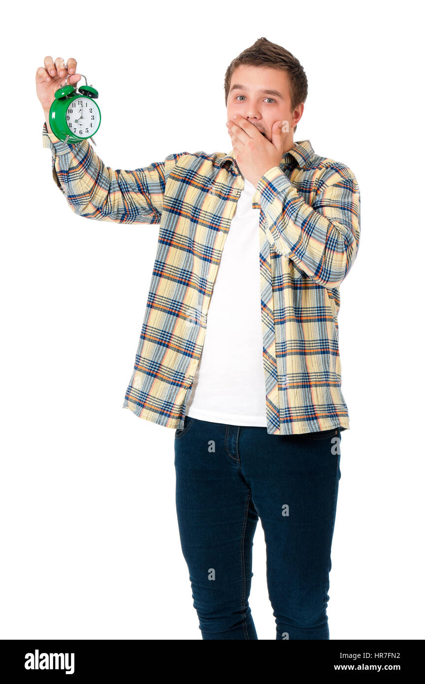Young man with alarm clock isolated on white background Stock Photo - Alamy
